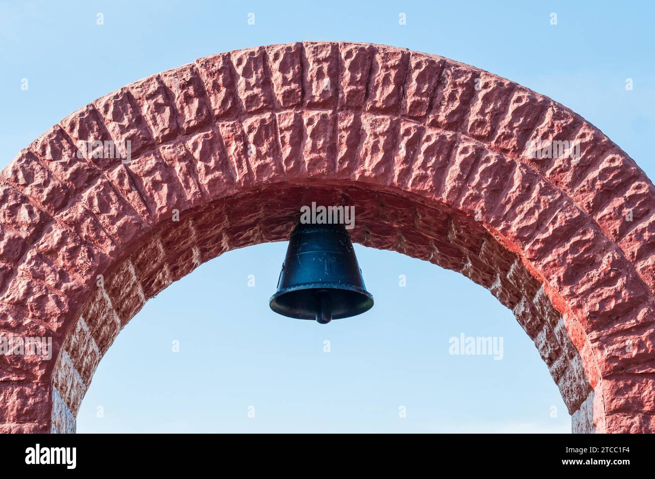 Church christian bell with arch on a background of blue sky in ...