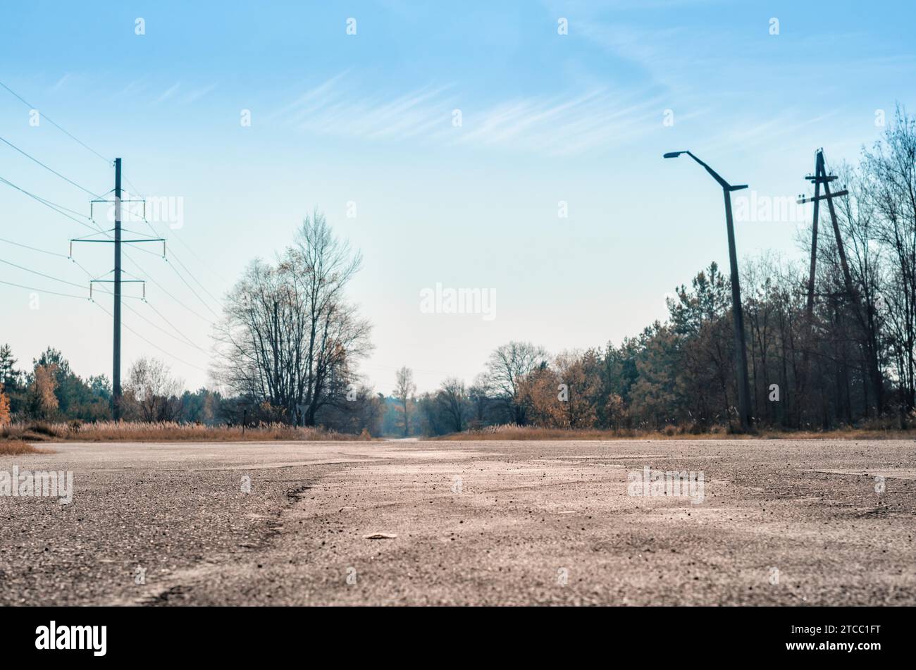 Empty road to Chernobyl Ukraine trees and poles against the blue sky ...