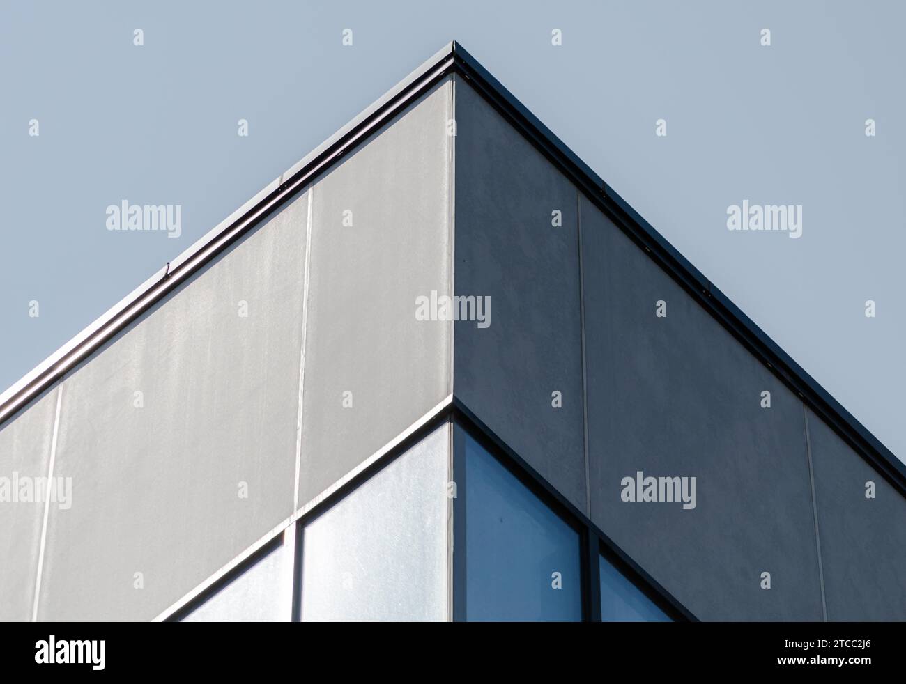Corner of a concrete building with windows Stock Photo - Alamy