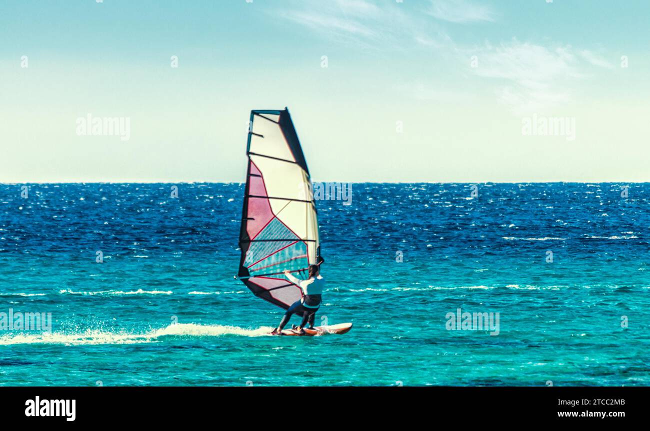 Young surfer girl rides a sail in the Red Sea in Sharm el Sheikh Stock ...