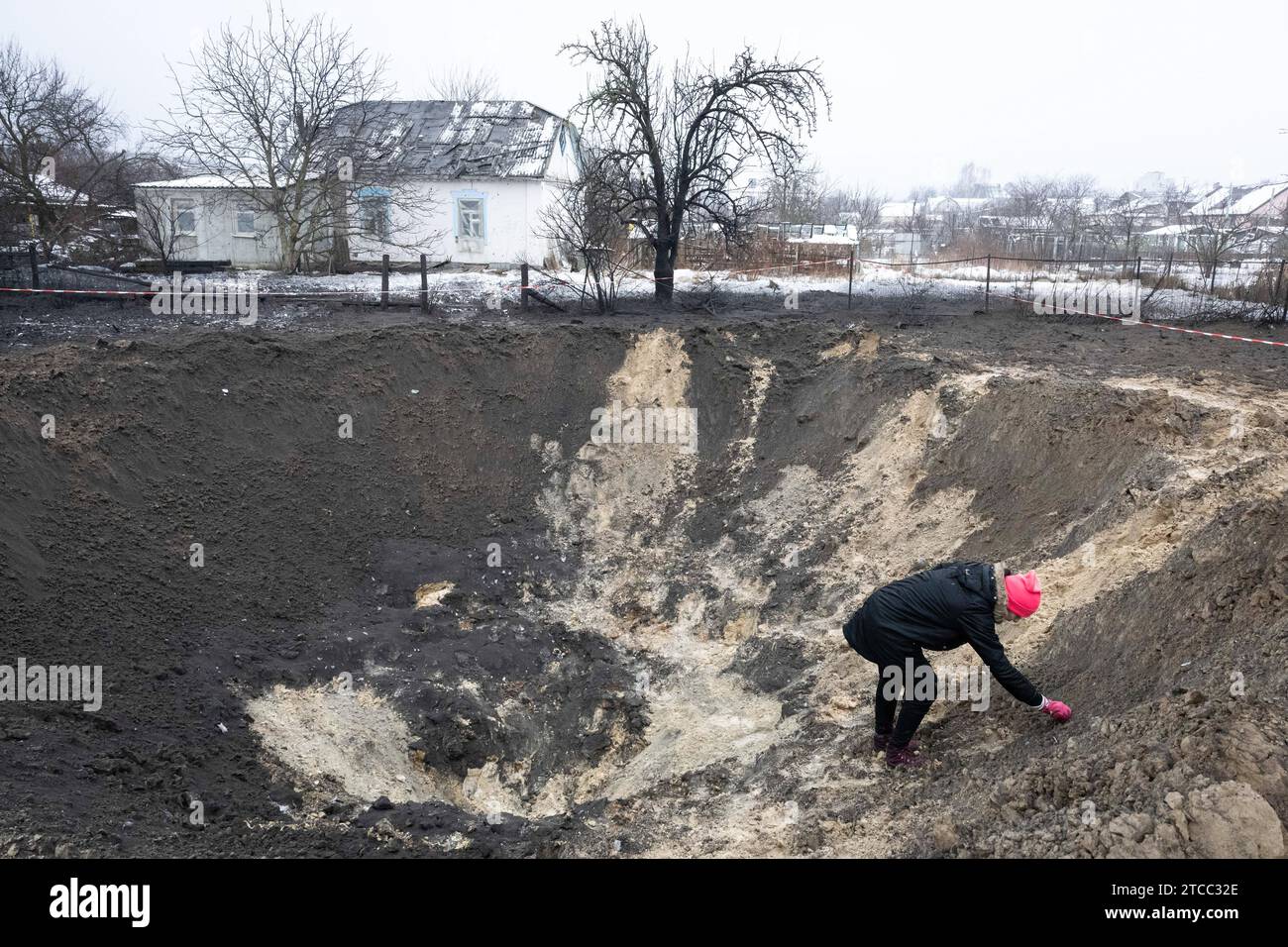 Kyiv, Ukraine. 11th Dec, 2023. A woman collects rocket fragments from a ...