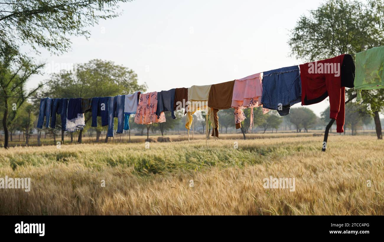 After being washed, Colorful clothing dries on a clothesline in the ...