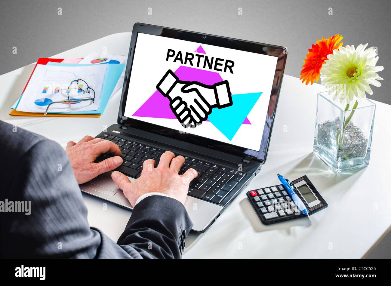 Man typing on a laptop showing a partner concept Stock Photo - Alamy