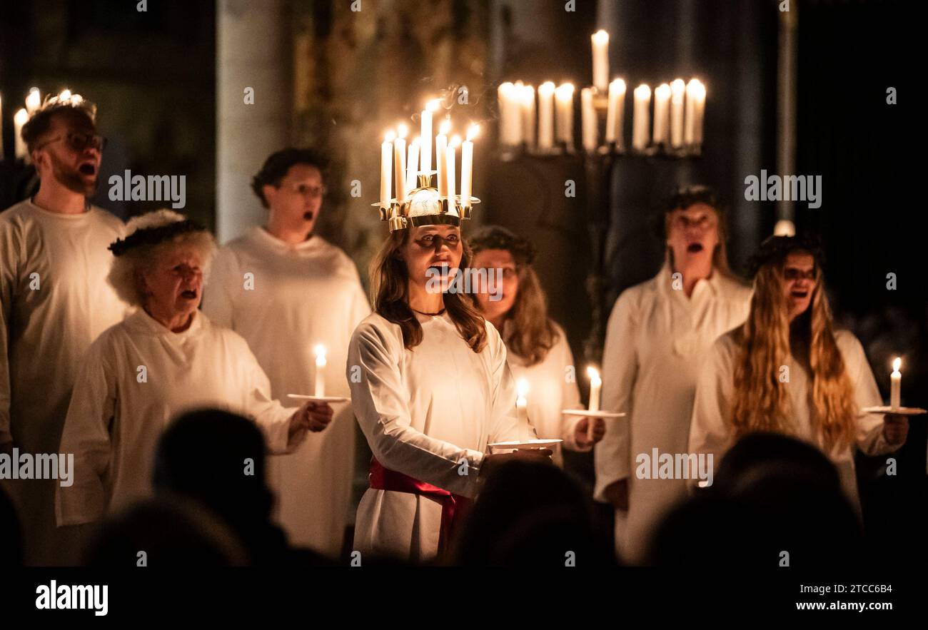 Linnea Isén wears a crown of candles symbolising St Lucy as she leads ...