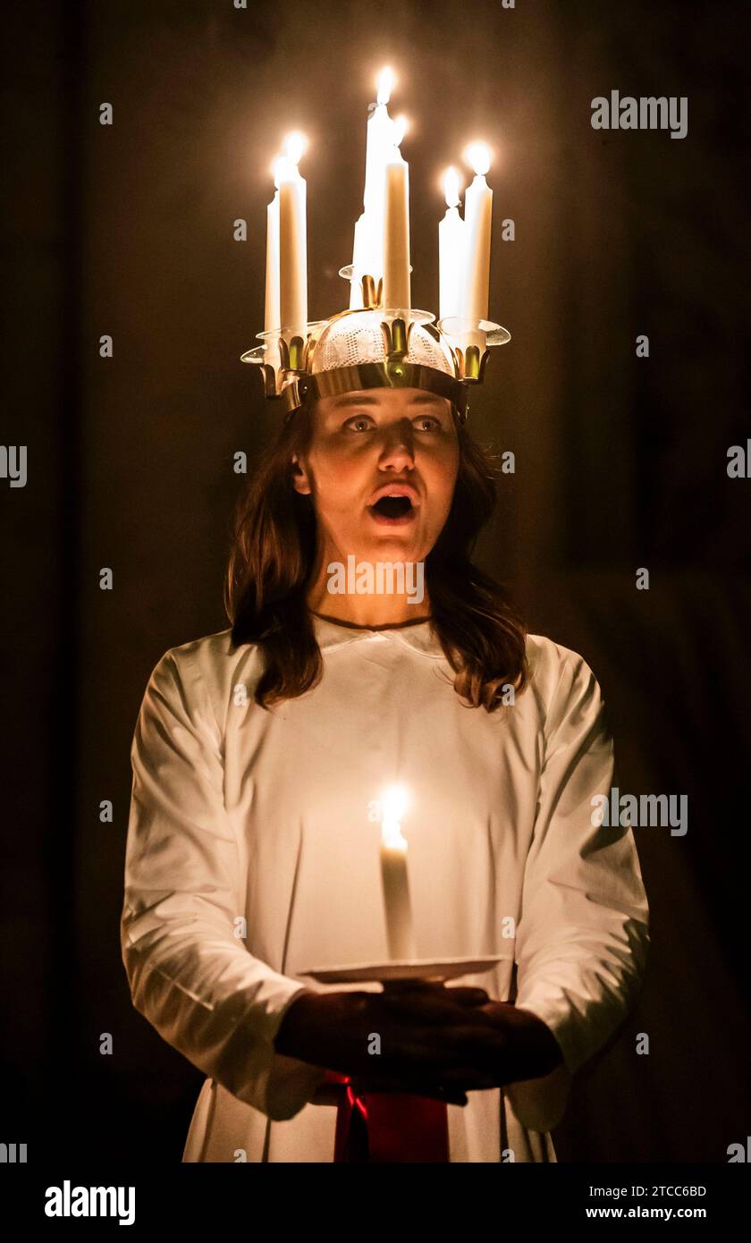 Linnea Isén wears a crown of candles symbolising St Lucy as she leads ...