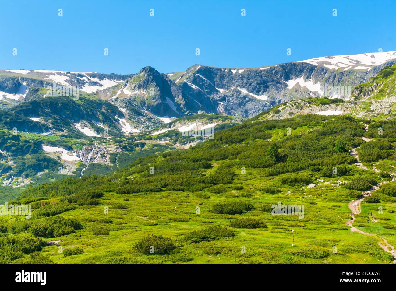 Spring green foliage and snow Rila Mountains by Rila Lakes in Bulgaria ...