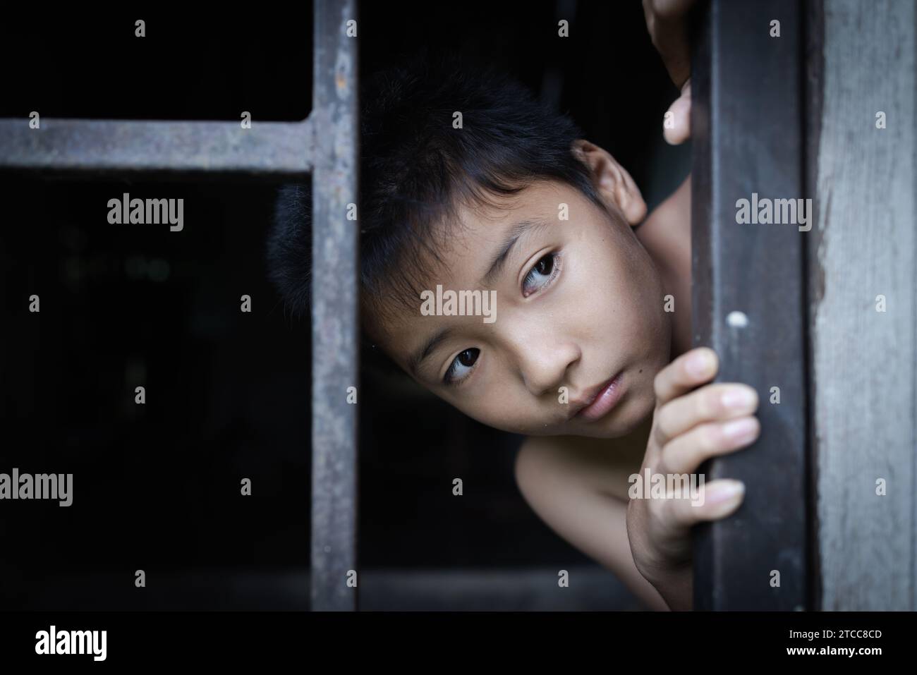 The child captured the iron cage with sadness and despair. The concept ...