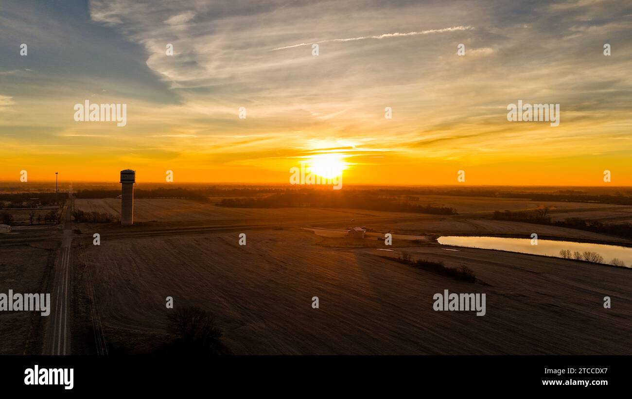 A breathtaking view of a lush green landscape under a vibrant orange ...