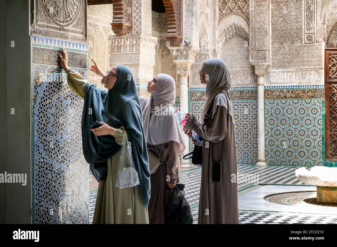 Fez, Morocco: three Arab women visit the Al-Attarine Madrasa (Islamic ...
