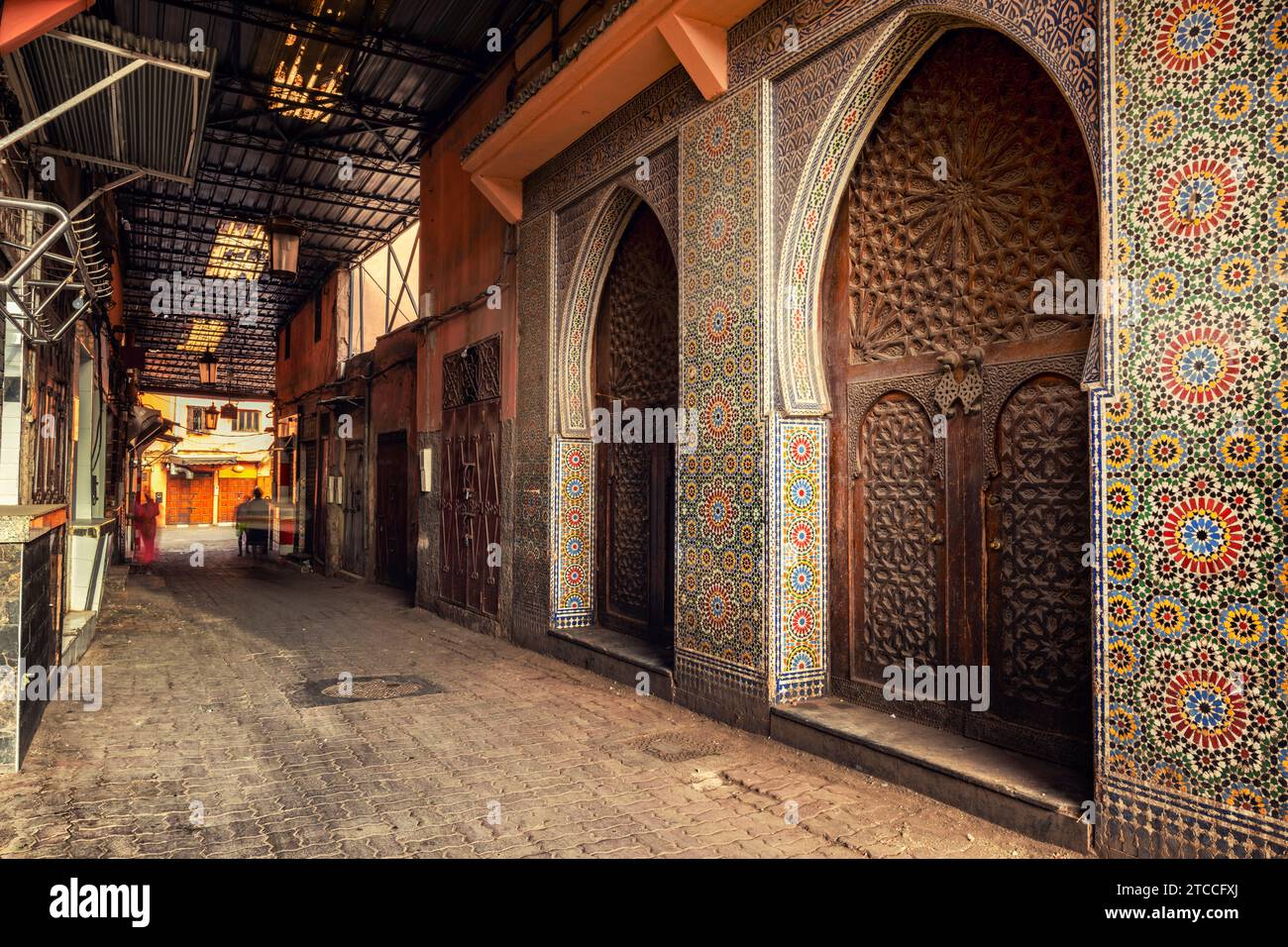 Beautiful Moroccan building with mosaic and wooden doors facing on an ...