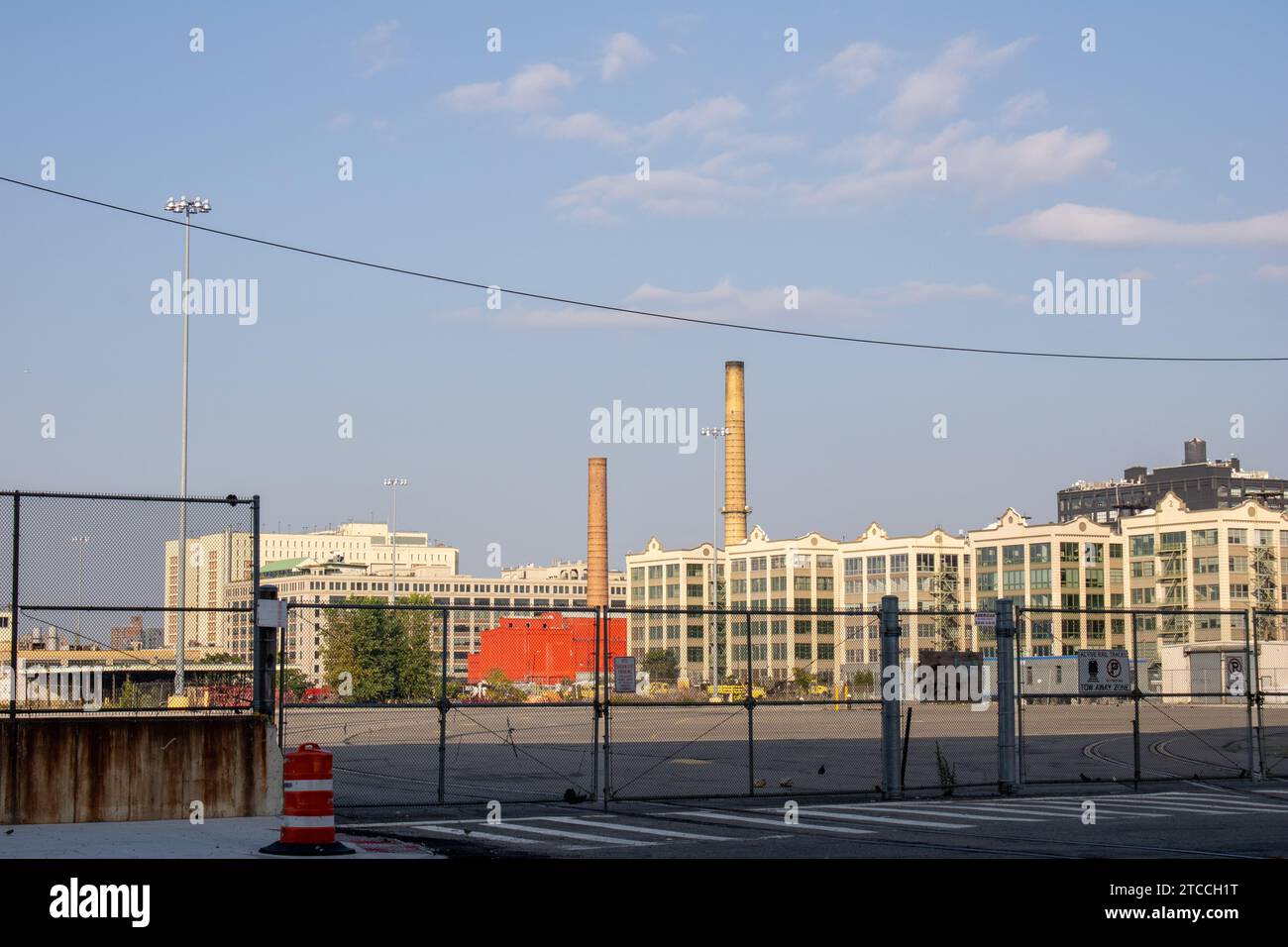 A cityscape with tall industrial buildings in the background, behind a ...