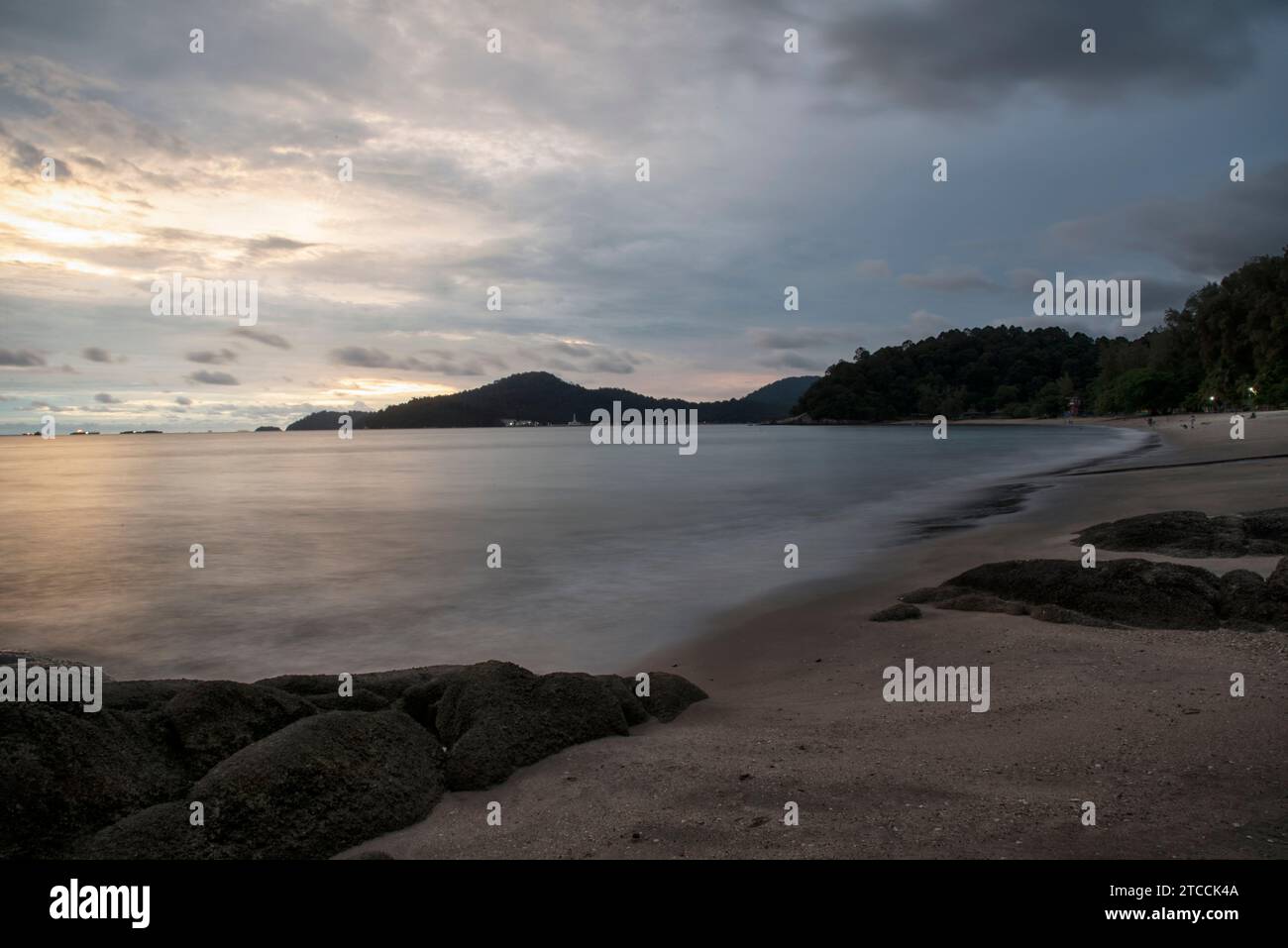 slow exposure shots of the sea waves along the rocky beach Stock Photo ...