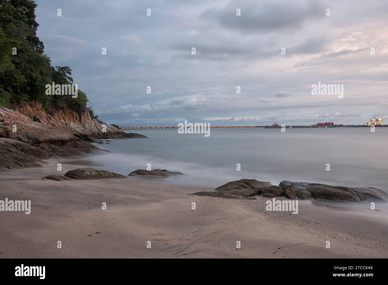 slow exposure shots of the sea waves along the rocky beach Stock Photo ...