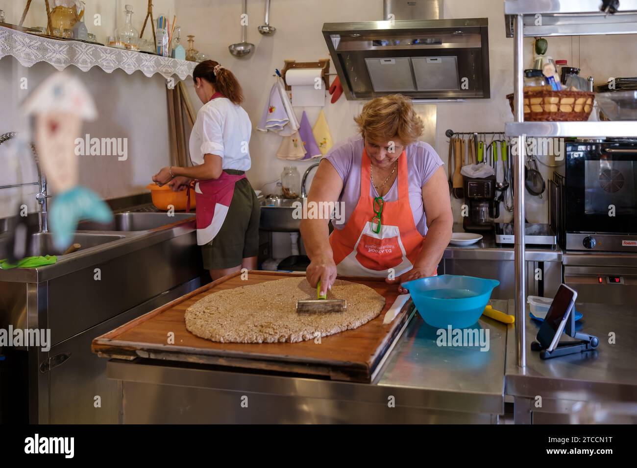 Ios, Greece - September 13, 2023 : View of a woman preparing the ...