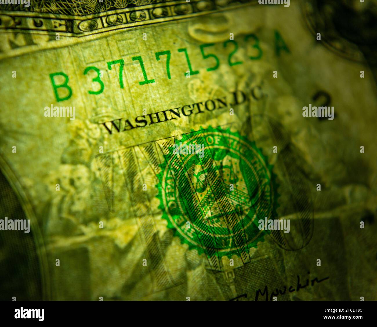 A closeup macro shot of a paper currency bill, with various elements of ...