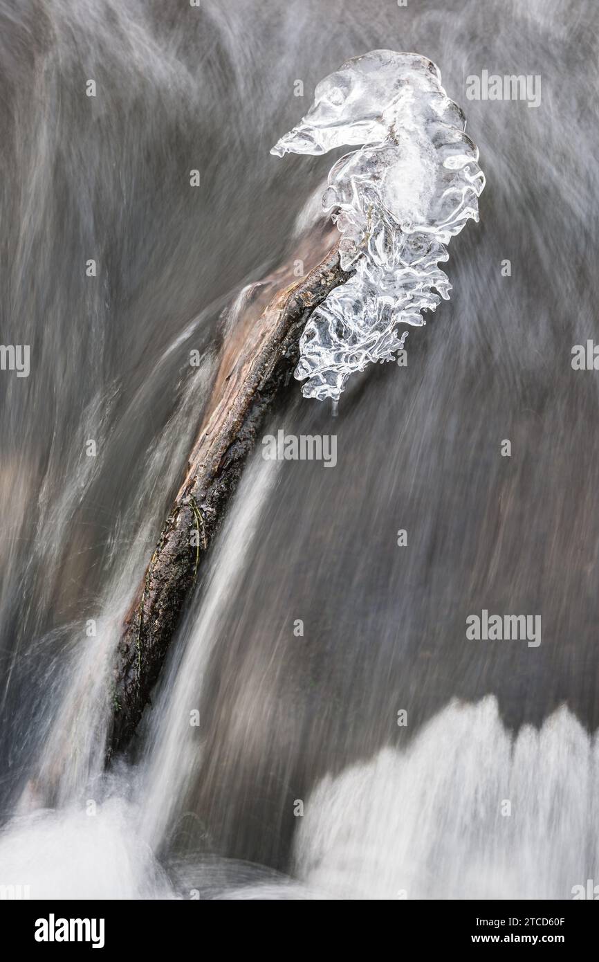 Frozen waterfall cascades over icy branch in scenic river Stock Photo ...