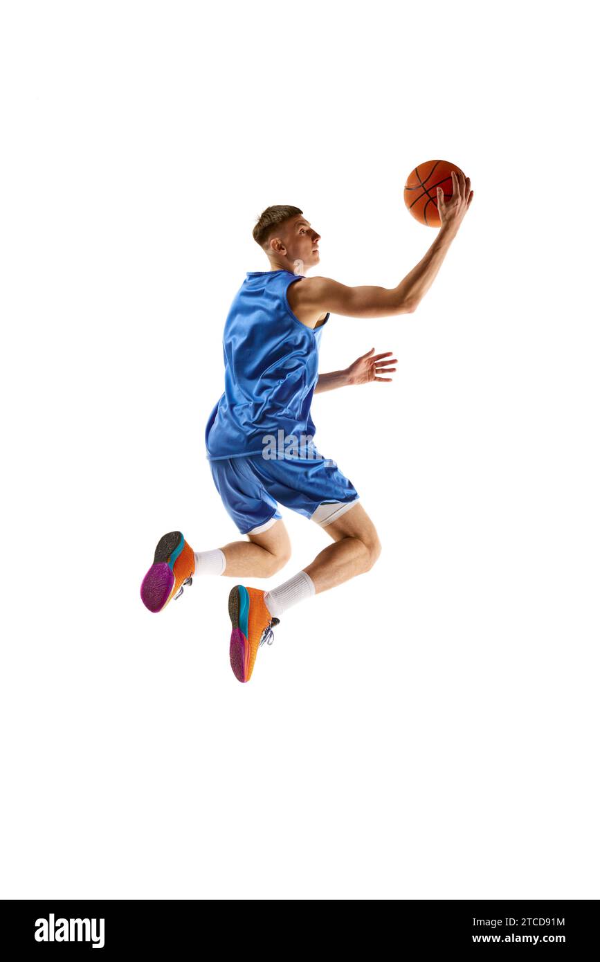 Slum dunk. Full-length image of young guy, basketball player in motion ...