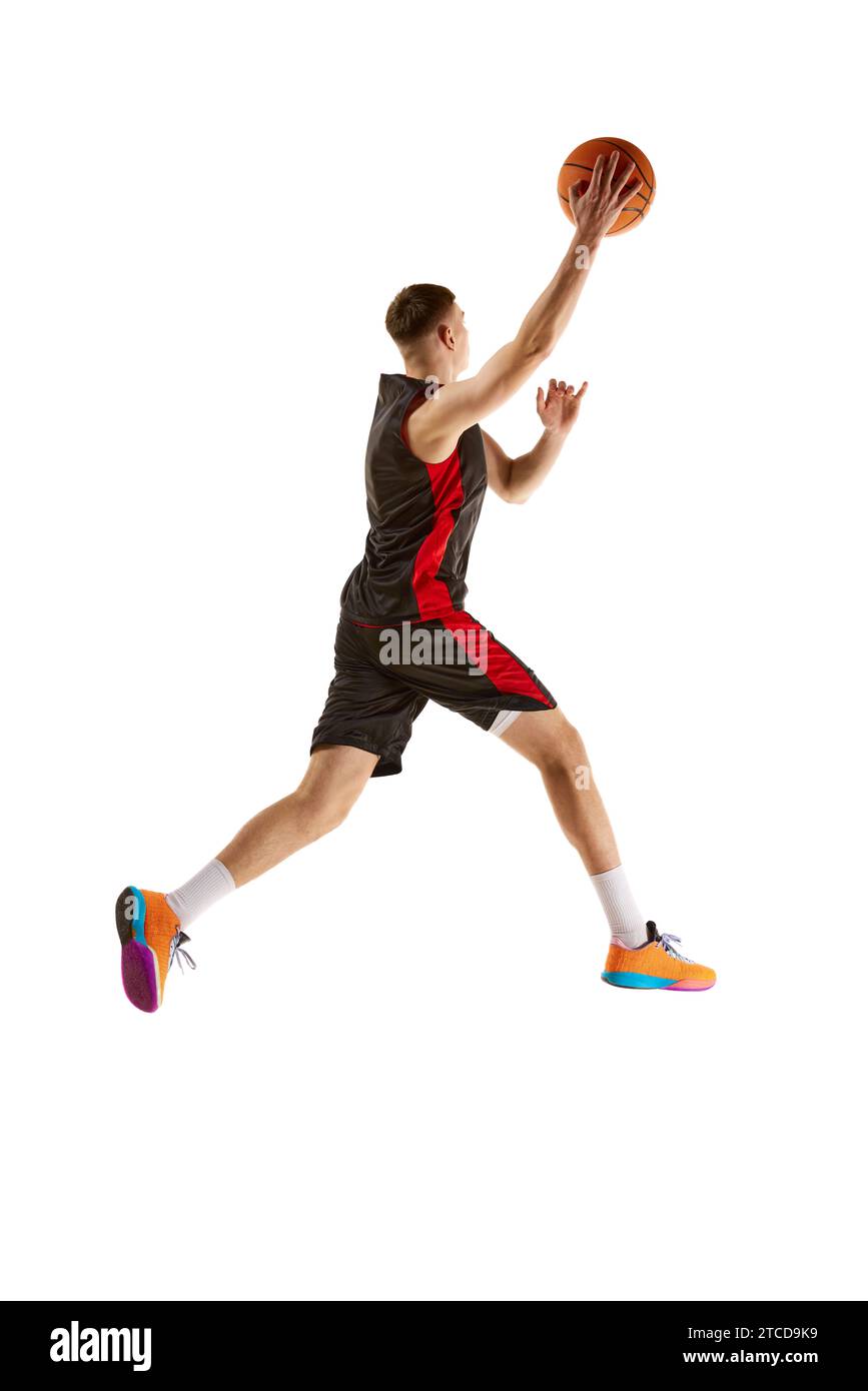 Young competitive guy, basketball player in uniform playing, training ...