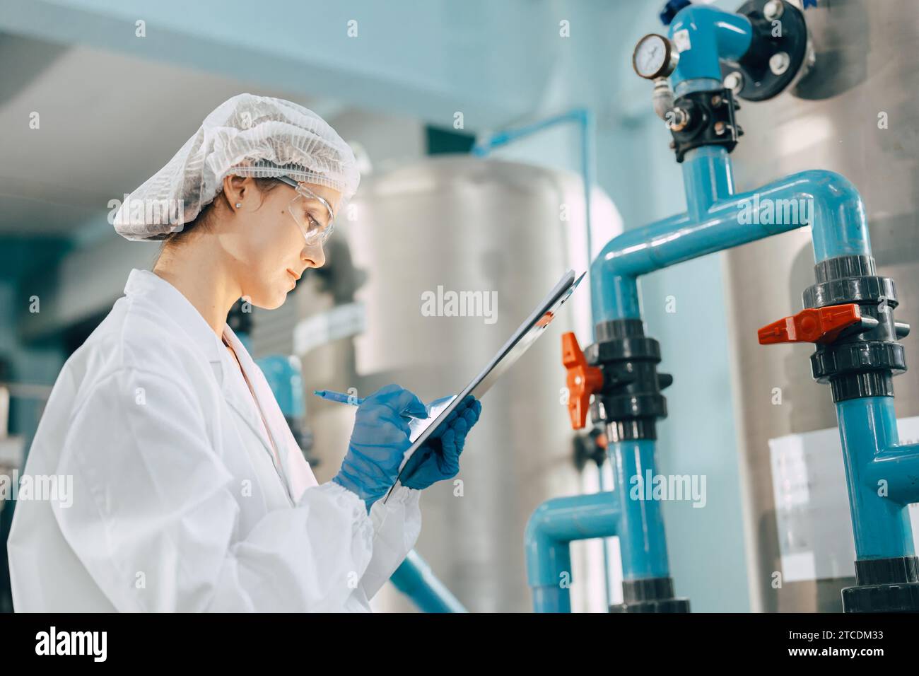 Drinking water factory purification process. Hygiene factory worker ...