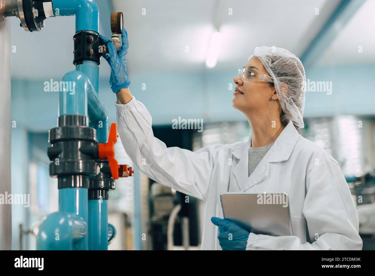 Drinking water factory purification process. Hygiene factory worker ...