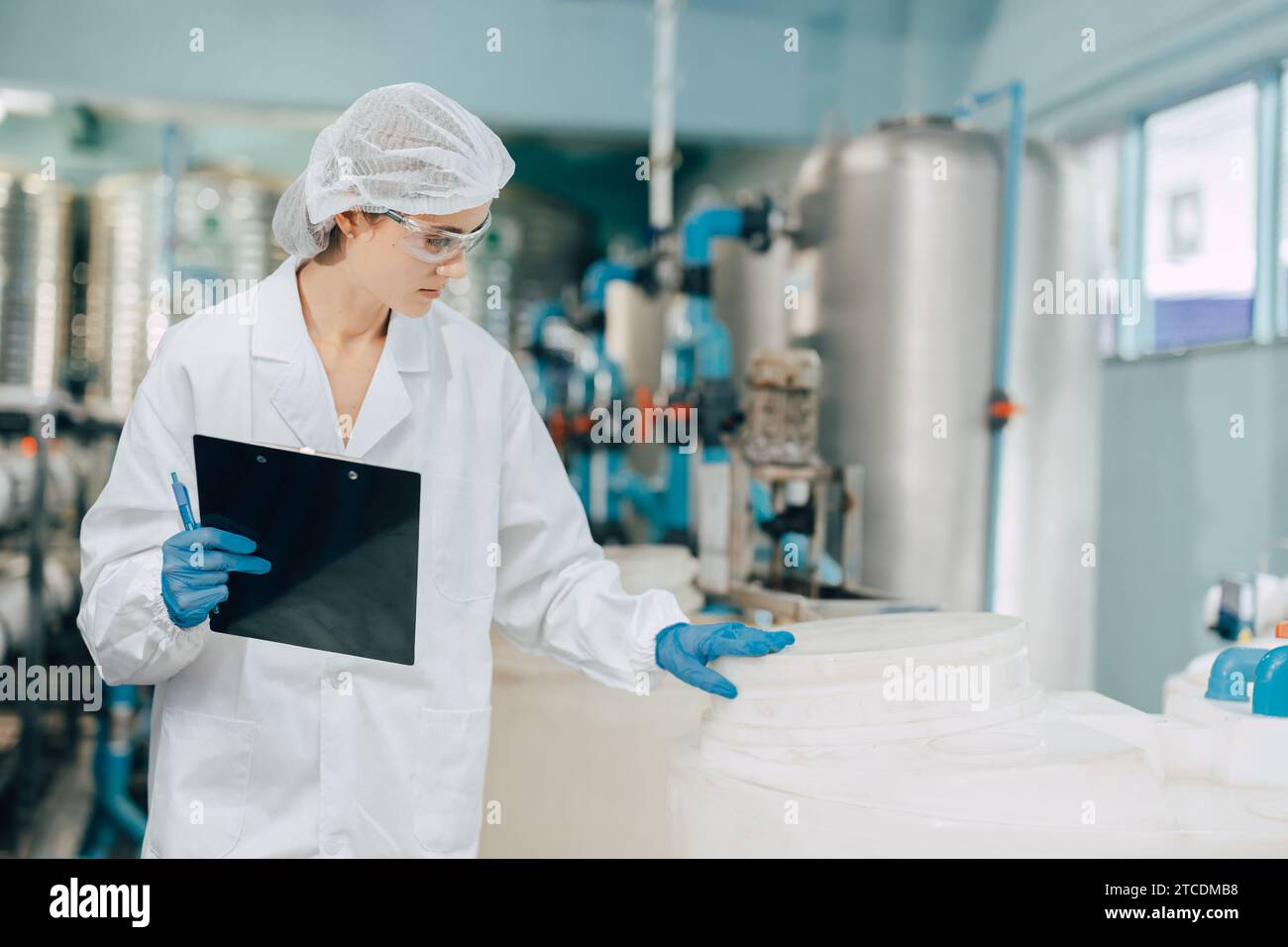 science worker work in water treatment plant checking quality and ...