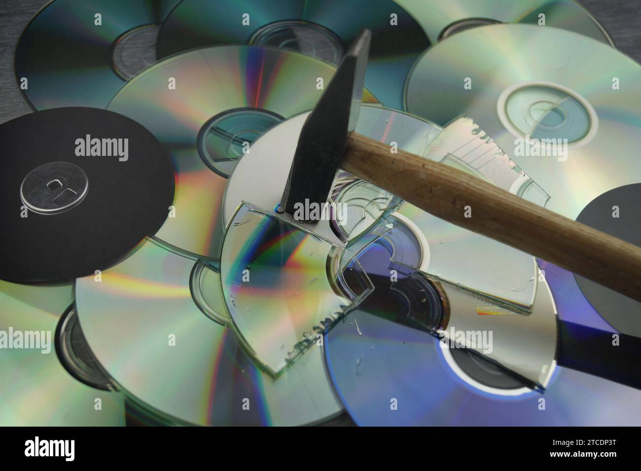 destroyed DVDs and hammer, symbol picture for hacker attack Stock Photo ...