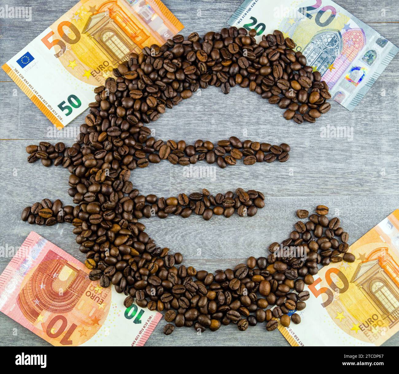 Euro sign, formed with roasted coffee beans, with Euro bills, coffee ...
