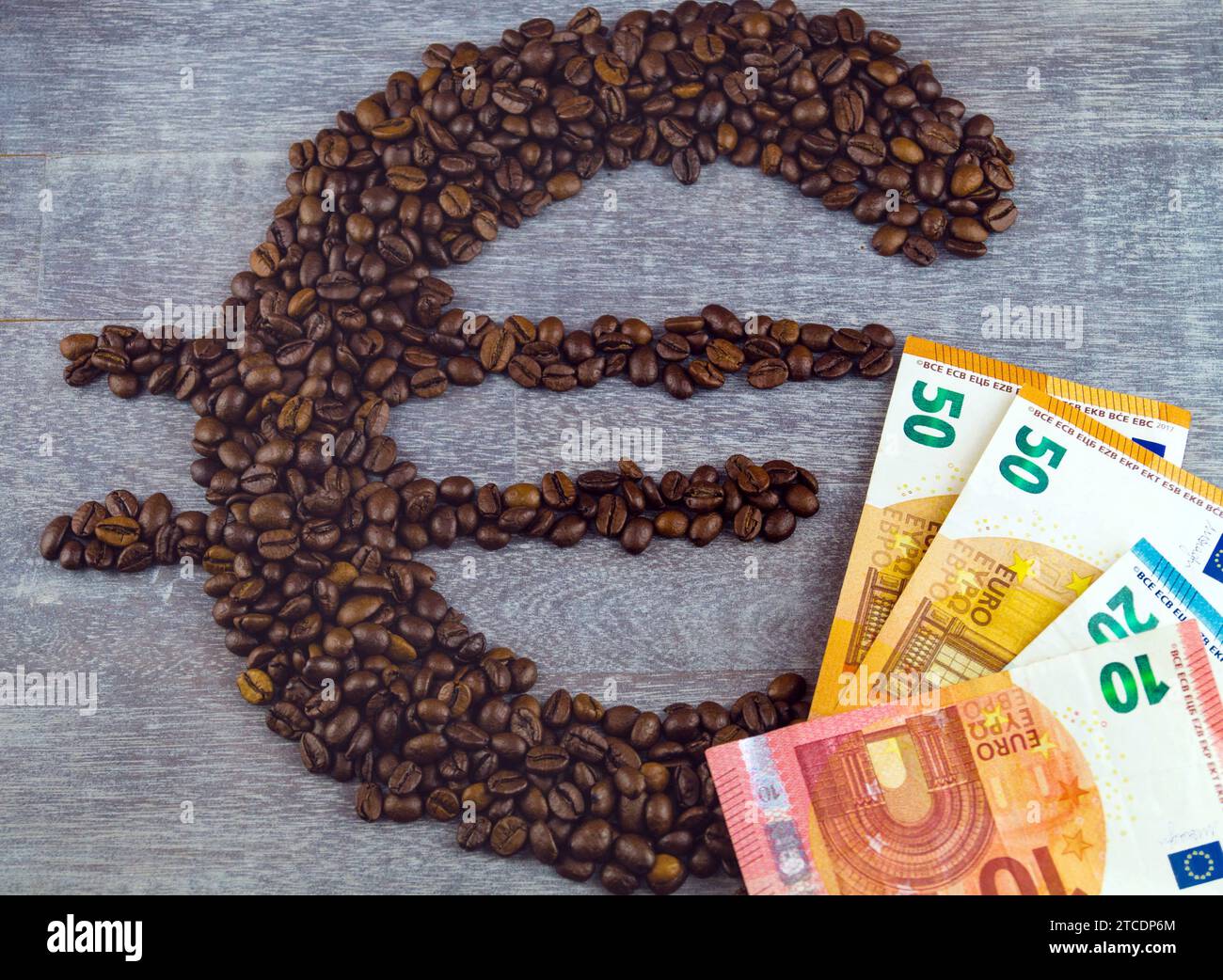 Euro sign, formed with roasted coffee beans, with Euro bills, coffee ...