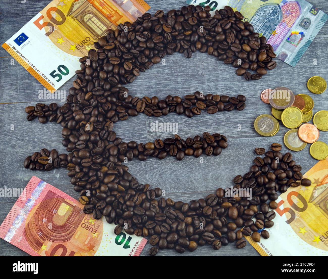 Euro sign, formed with roasted coffee beans, with Euro bills, coffee ...