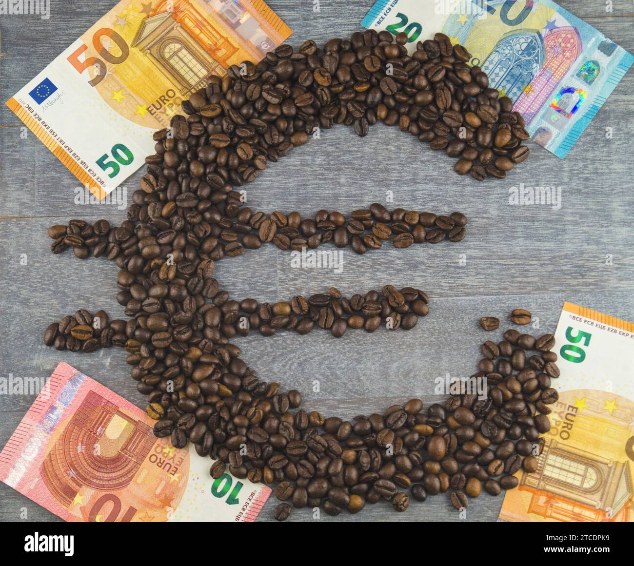 Euro sign, formed with roasted coffee beans, with Euro bills, coffee ...