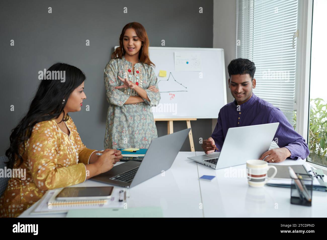 Team of Indian startuppers discussing ideas and pitch decks in daily ...