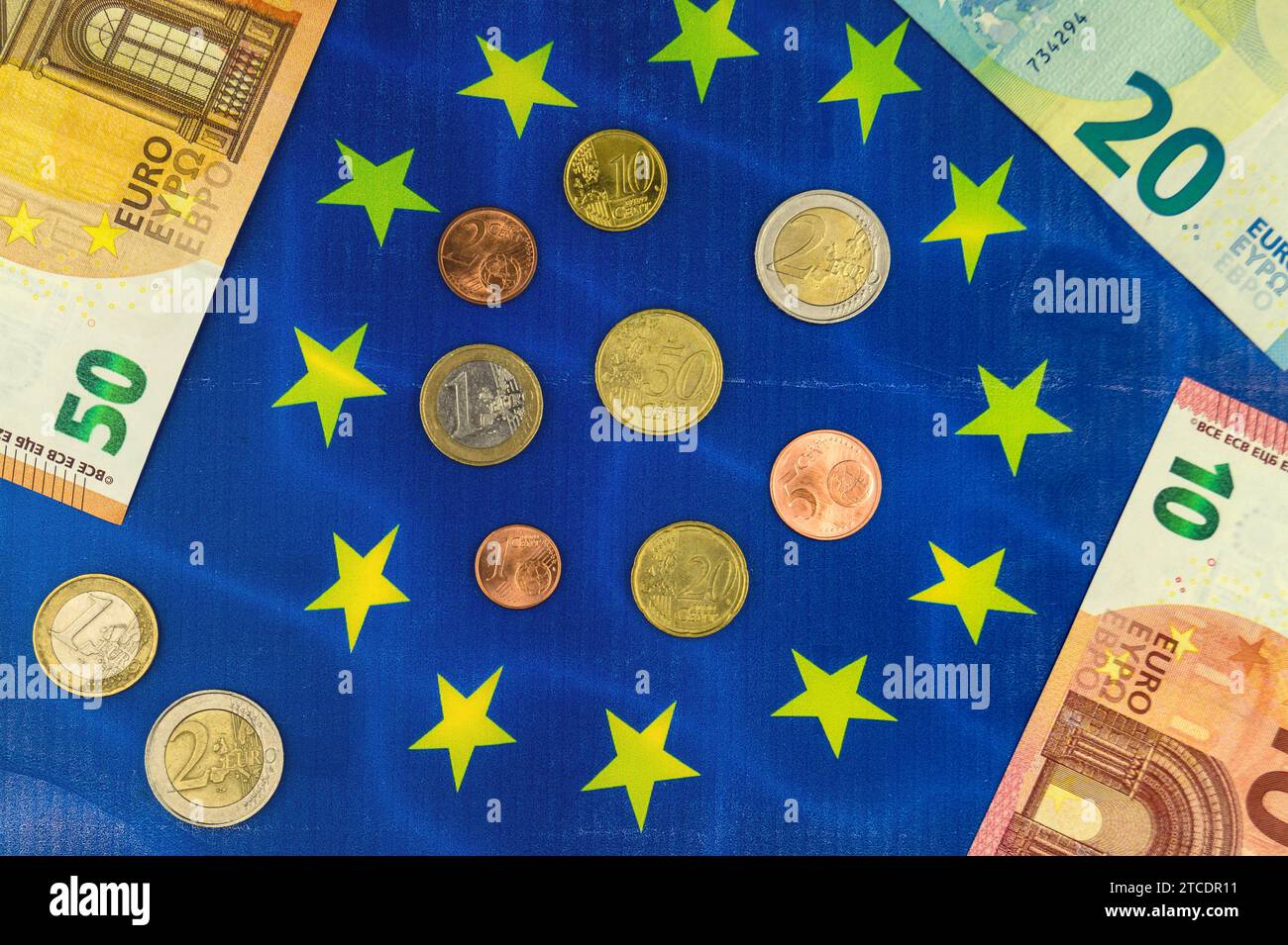 flag of EU with Euro bills and coins, Europe Stock Photo - Alamy