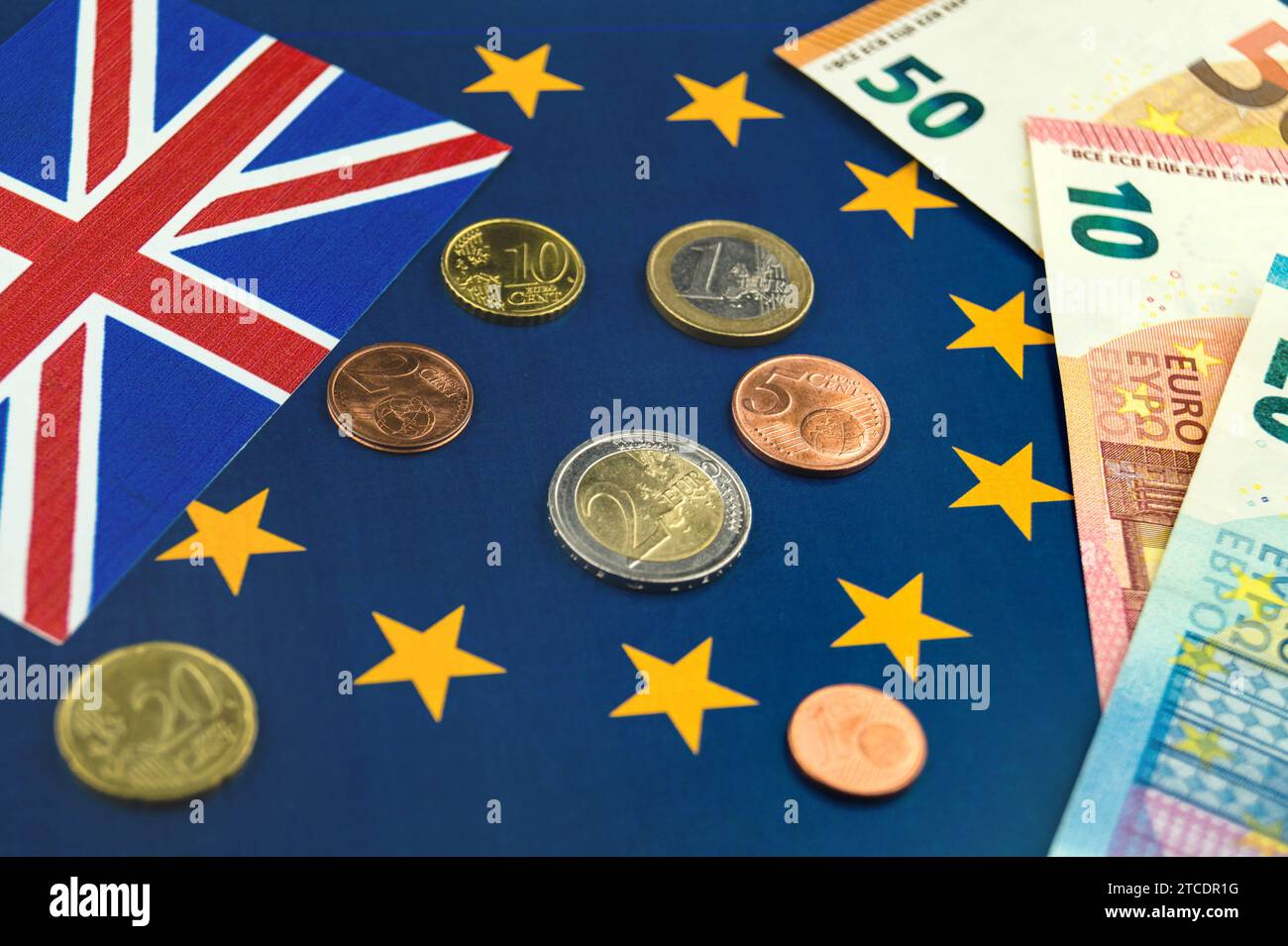 flag of EU with Euro coins, bills and flag of GB, Europe Stock Photo ...