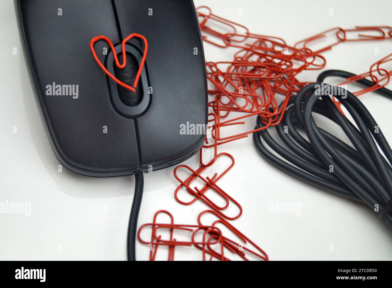 computer mouse with red paper-clips, one of them heart-shaped, love in ...