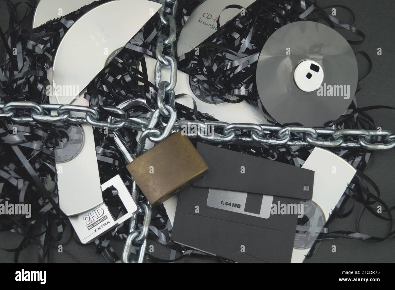 chain with padlock around destroyed data carriers, symbol for data ...