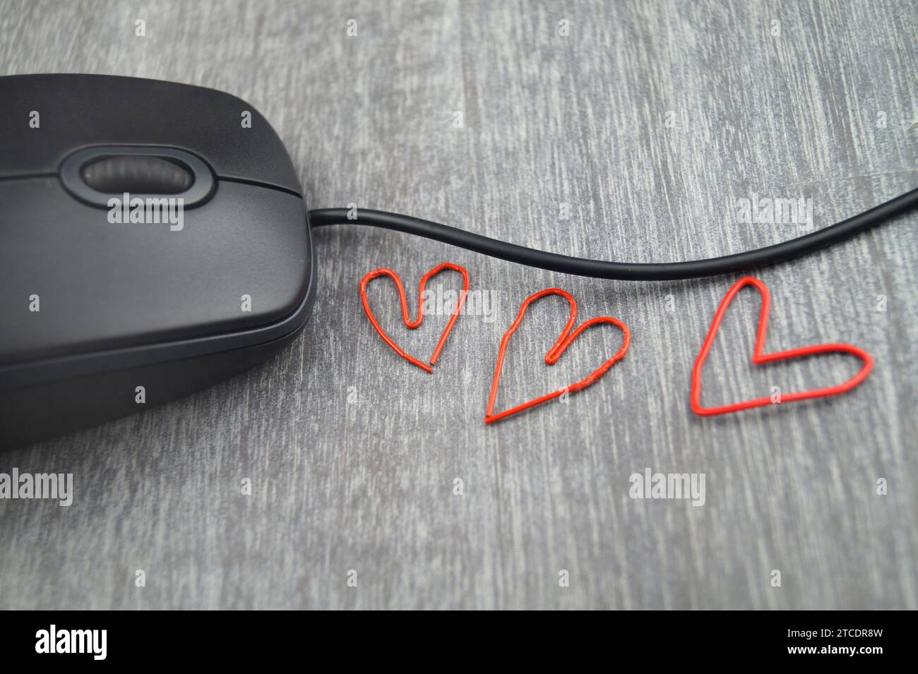 computer mouse with red, heart-shaped paper-clips, love in the office ...