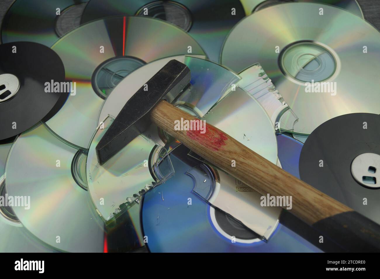 destroyed DVDs and hammer, symbol picture for hacker attack Stock Photo ...