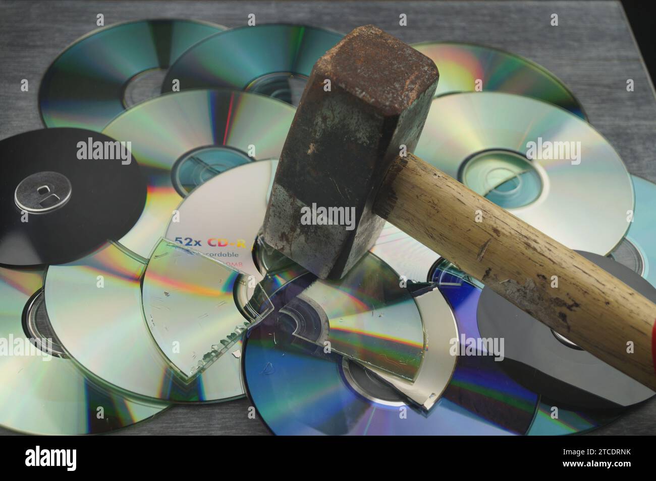 destroyed DVDs and hammer, symbol picture for hacker attack Stock Photo ...
