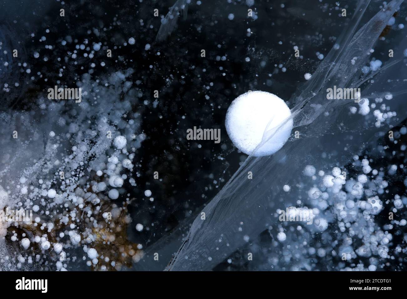 Methane bubbles, cracks and snow on surface of Baikal lake create ...