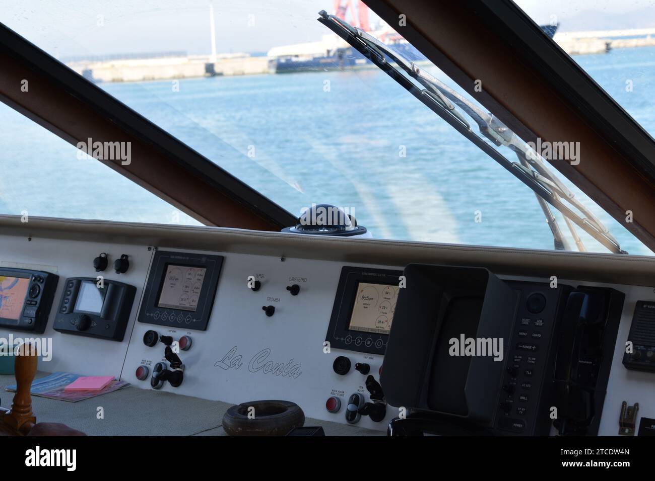 Switches, buttons, instruments and a glass compass in the bridge of the ...
