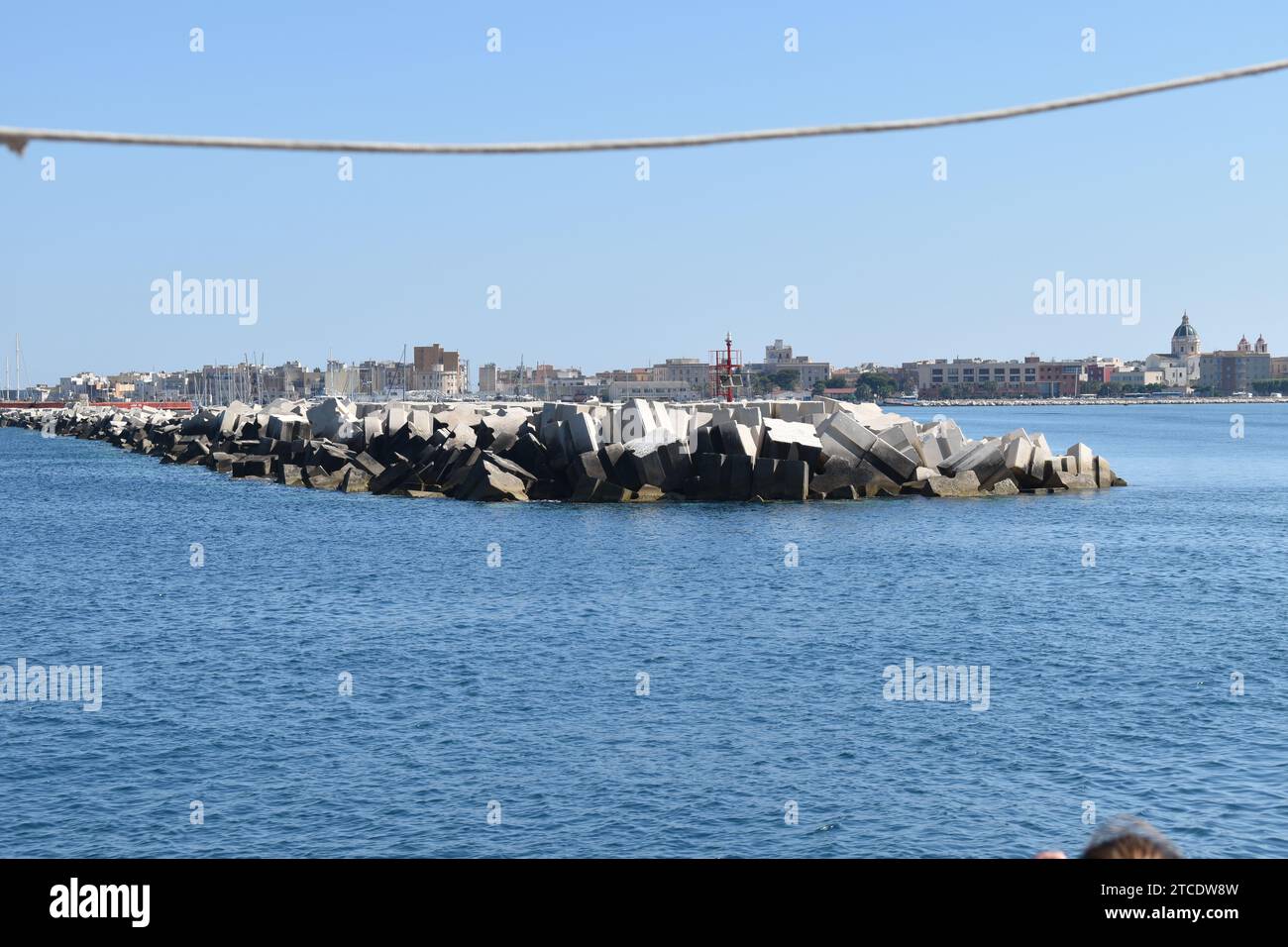 A long line of heaped special shaped concrete blocks forming a sea wall ...