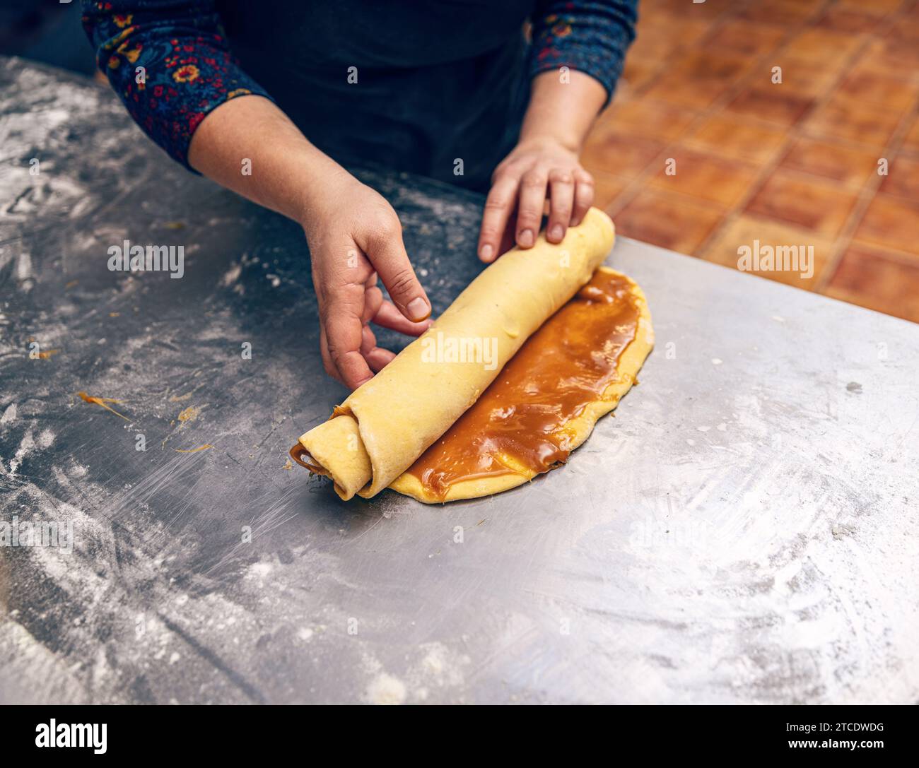 Rolling salted caramel filling dough for make babka. Bakery procedure ...