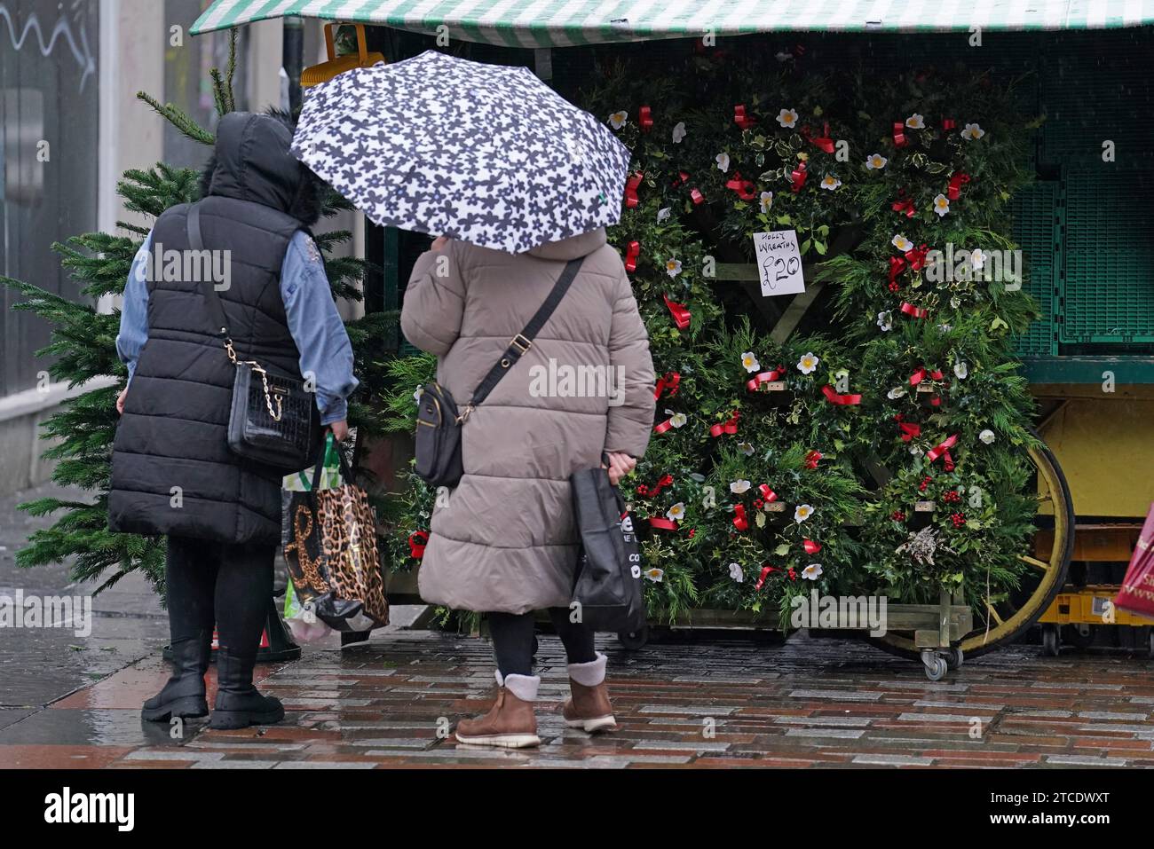 People look at Christmas wreaths in Glasgow, as wet weather warnings ...