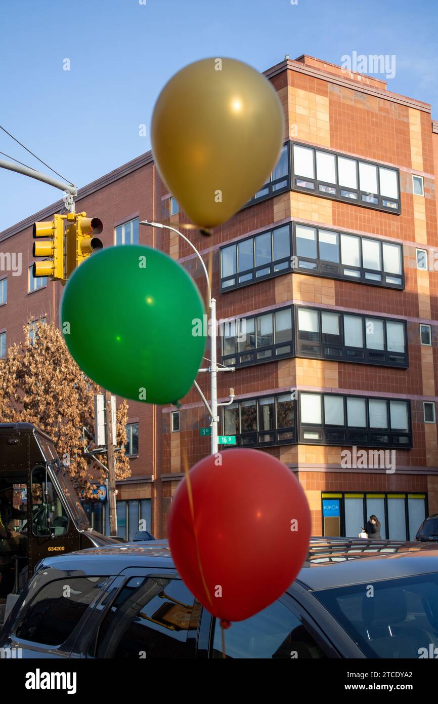 A vibrant street scene featuring colorful balloons suspended from a ...
