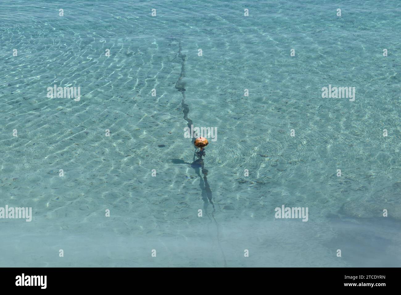 Single buoy floating in light blue shallow water Stock Photo - Alamy