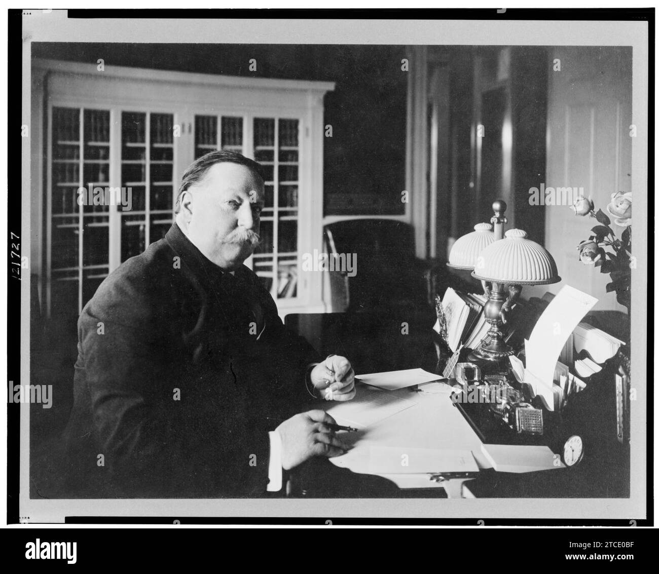 William Howard Taft, half-length portrait, seated at desk, facing right ...