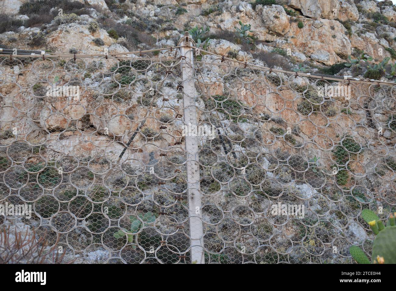 Chain link fence reinforced with steel rings to protect from falling ...