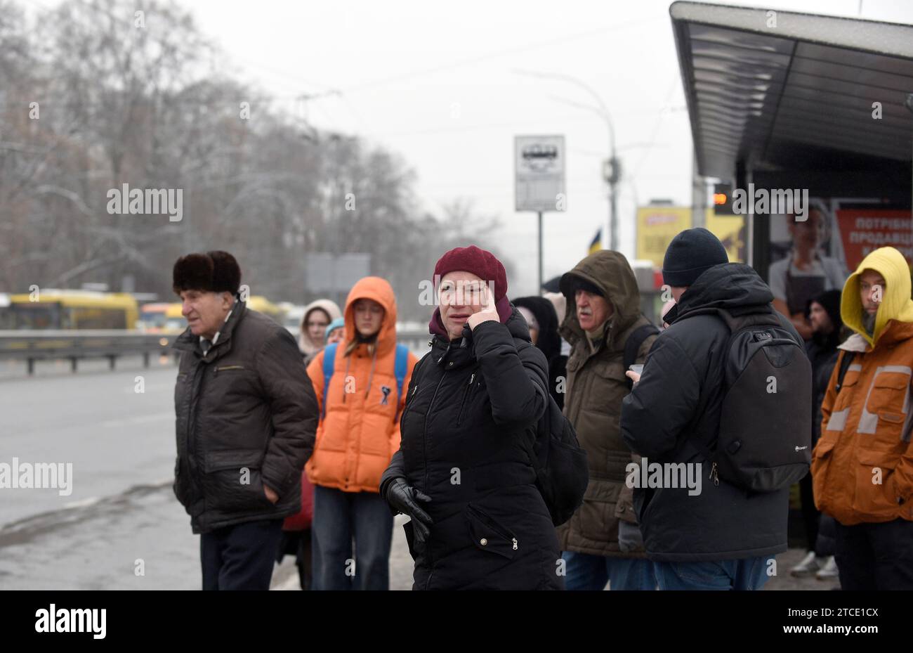 KYIV, UKRAINE - DECEMBER 11, 2023 - Passengers stay at a stop as ...