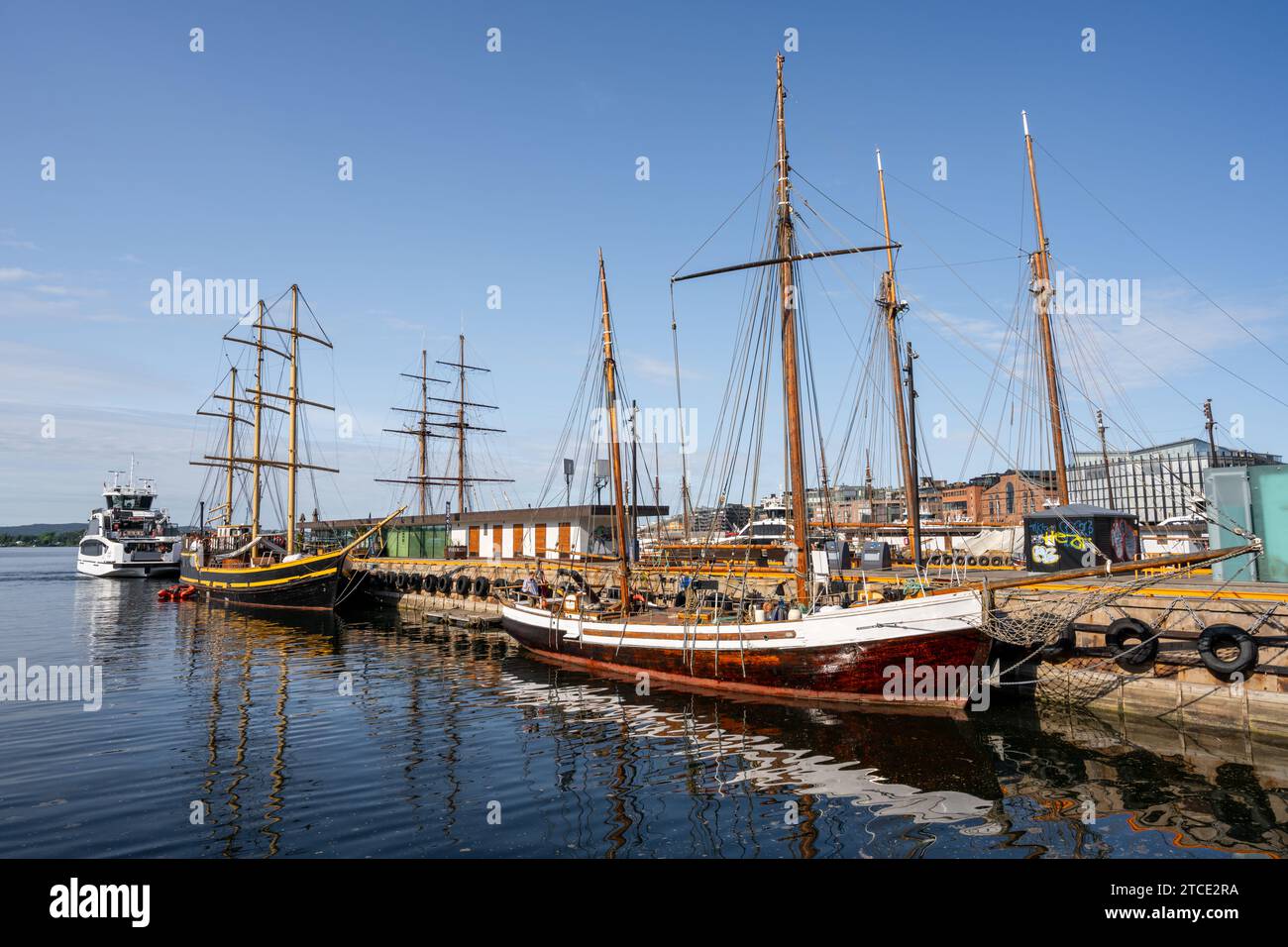 Tall masted sailing ships moored up along Oslo water front at Aker ...