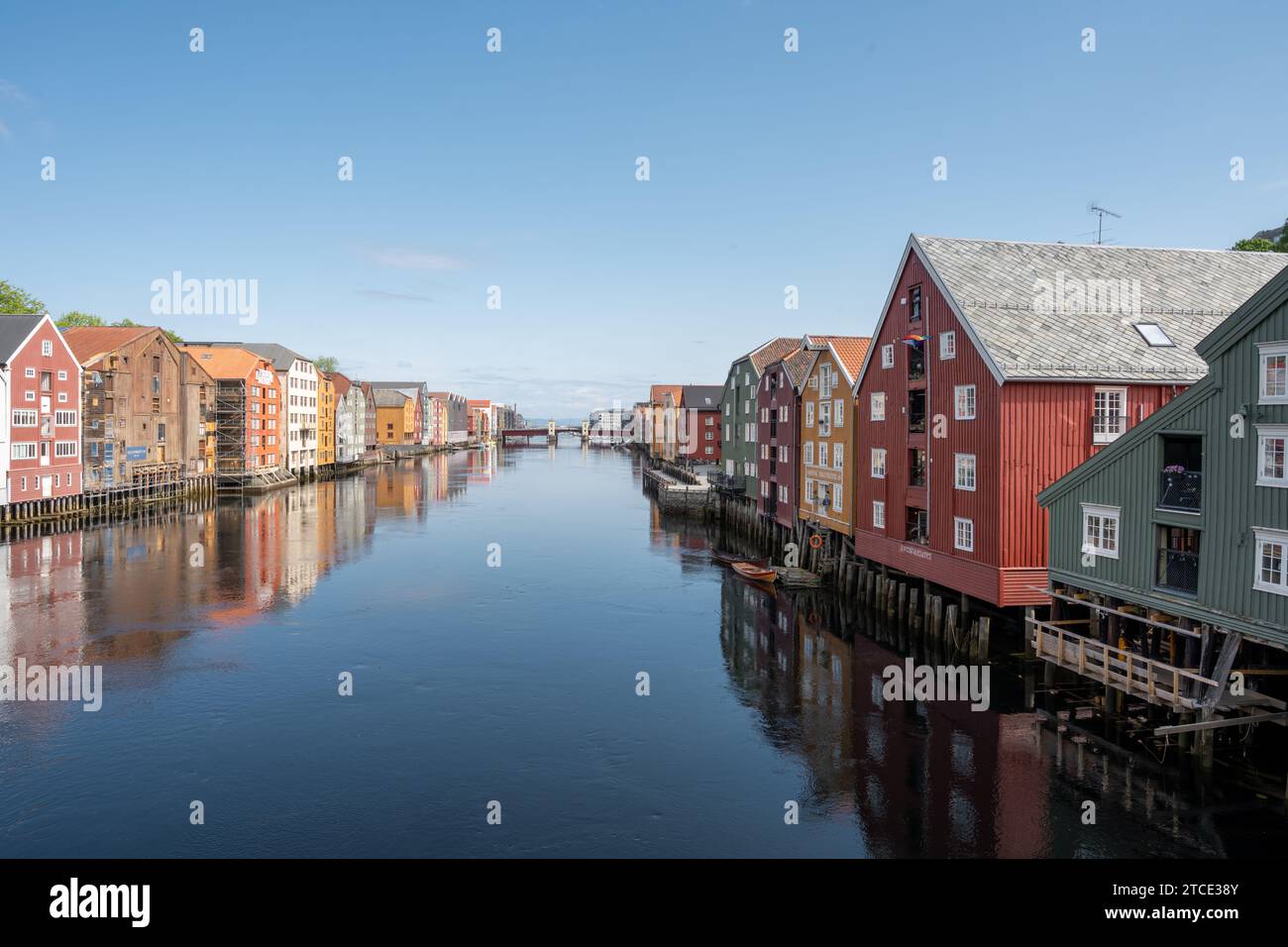 Colourful old buildings of Bryggen reflected in the waters of Nivelda ...